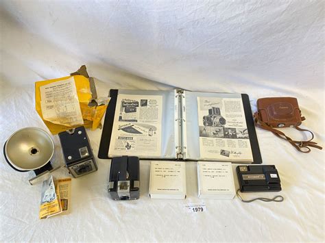 Assorted Camera Memorabilia And Accessories Ansco Camera In Case Camera Ads In Binder Etc