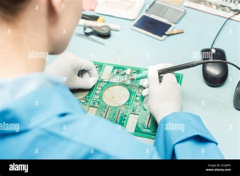Technician Soldering Components To A PCB In Electronics Factory Stock Photo Alamy
