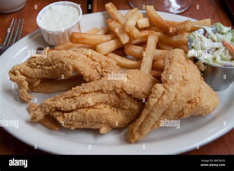 Deep Fried Catfish Served With Fries Coleslaw And Tartar Sauce At A