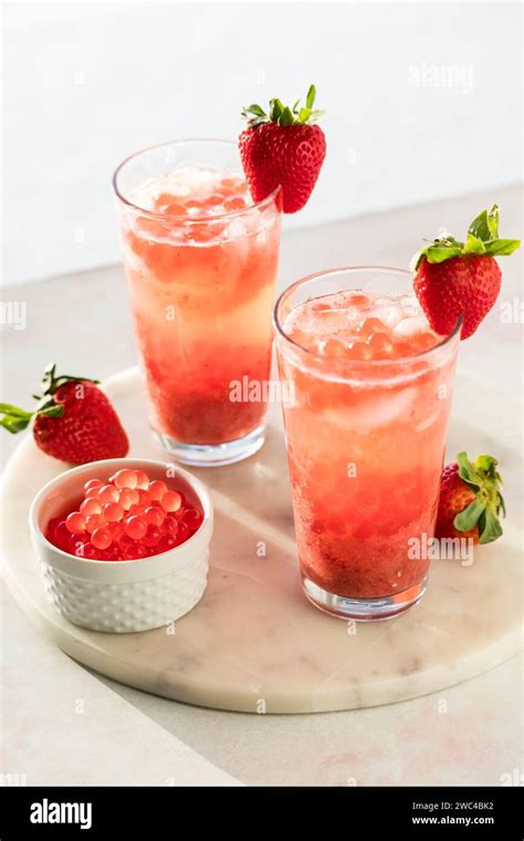 Glasses Of Fresh Strawberry Lemonade With Bubble Peals Against A