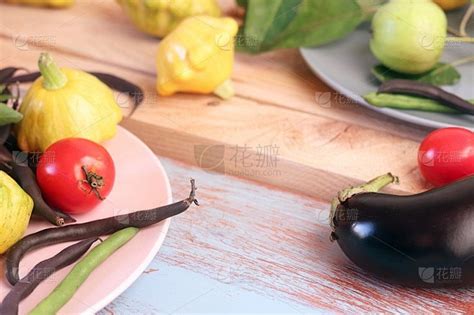 鲜亮的蔬菜水果和鲜花摆放在木桌上