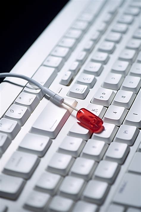 The Mouse And The Syringe Is Hovering Next To A Keyboard Background