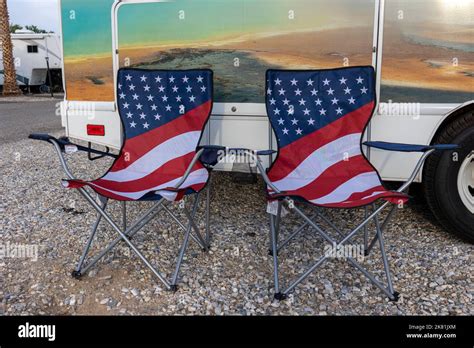 Two Folding Camping Chairs With The American Flag Printed On Them