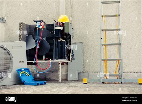 Broken Outdoor Air Conditioner Unit In Need Of Fixing Next To