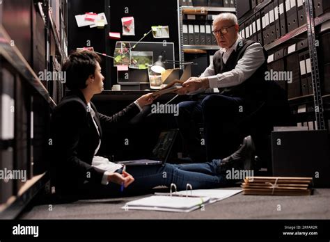 Police Officers Working Overtime At Criminal Investigations Checking Crime Scene Evidence Late