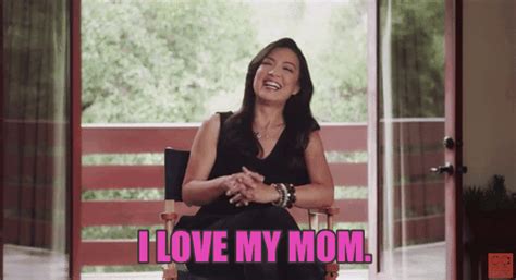 A Woman Sitting In A Chair Laughing With The Caption I Love My Mom