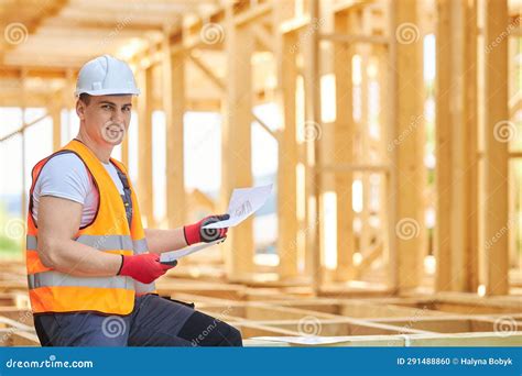 Young Architect Builder Engineer Constructing Wooden House In Forest