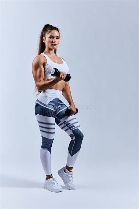 Well Built Slim Fit Girl Holding A Battle Rope Posing To The Camera