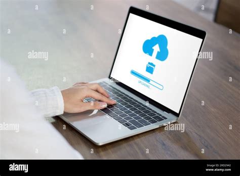 Woman Uses Her Laptop Showing A Prominent Cloud Icon A Symbol For Cloud Computing Services