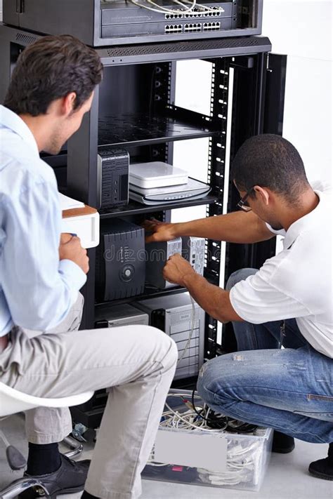 Server Room Man Or Electrician Fixing Electronics For Hardware