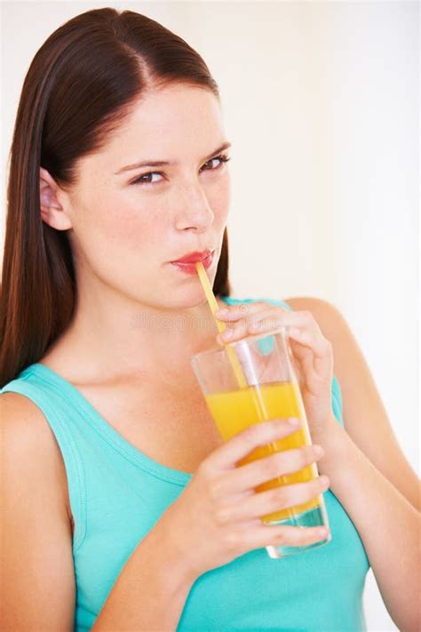 Enjoying A Fresh Glass Of Orange Juice Portrait Of A Beautiful Young