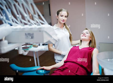 Beuatiful Female Dentist Posing And Smiling With Her Lovely Patient