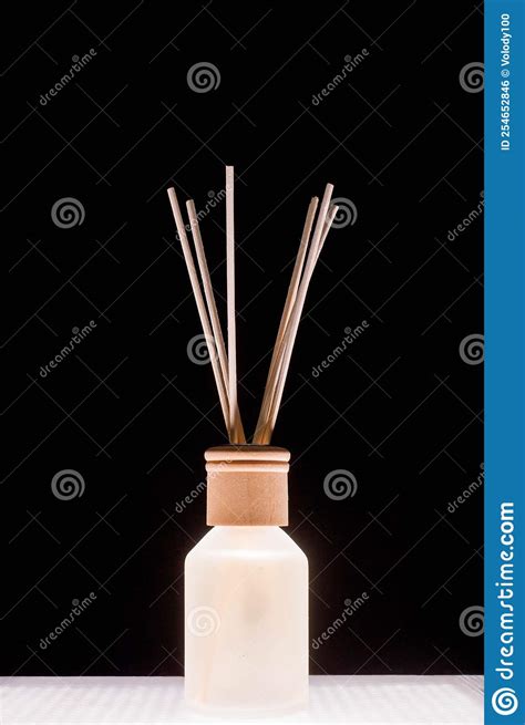 Oil Diffuser With Glass Amber Bottle And Orchid Flowers On White Table