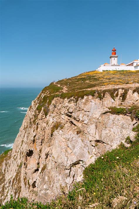 Scenic Lighthouse On Rocky Cliffs Overlooking Atlantic Ocean In Lisbon