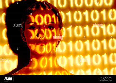 Horizontal Color Image Of An Adult Female With Binary Code Projected Onto Her Face Stock Photo