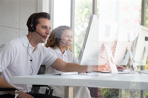 운영자 서비스 데스크 컨설턴트가 핸즈프리 전화로 이야기하고 미소짓고 있습니다 헤드셋이 있는 고객 지원 담당자 또는 콜 센터는 데스크톱 컴퓨터 개념에서 작동합니다 고객 서비스