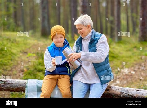 Grandmother With Grandson Drinking Tea In Forest Stock Photo Alamy