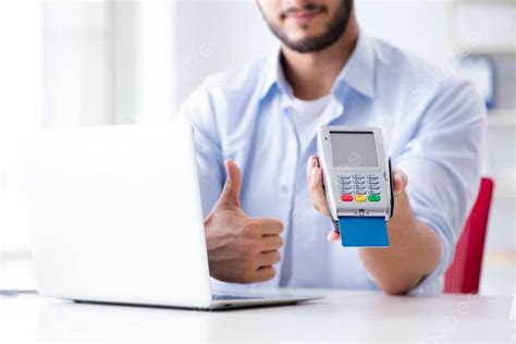 Man Processing Credit Card Transaction With Pos Terminal Photo Background And Picture For Free
