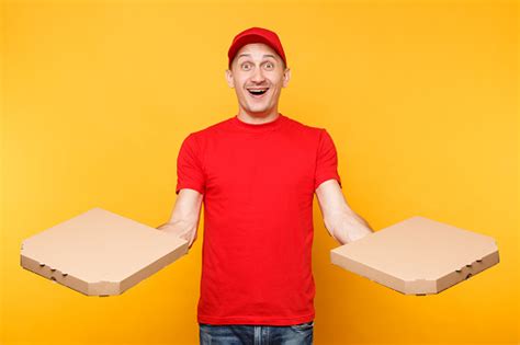 빨간 모자 티셔츠 주는 음식 주문 피자 상자 노란색 배경에 고립에 배달 남자 남성 직원 Pizzaman 또는 골 판지 Flatbox에서 이탈리아 피자를 들고 유니폼에 택배