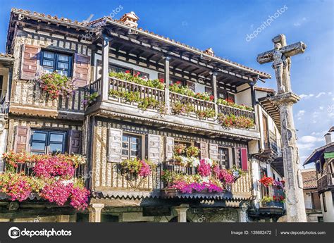 Stone Cross And Typical Architecture In Main Square Of La Alberc