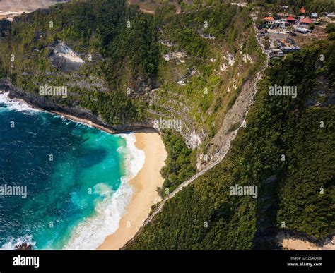 Aerial Shot Of Steep Rocky Steps Descending A Huge Cliff To A Tropical