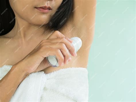 Premium Photo Woman Applying Deodorant Roll On Under Armpit After
