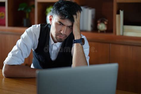 Portrait Of An Asian Man To Be Bored From Working On A Computer Stock