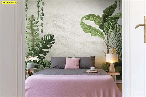 A Bed With Pink Sheets And Pillows In Front Of A Plant Mural On The Wall