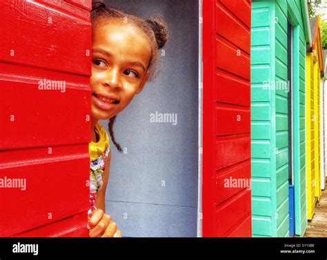 Girl Peeping From A Beach Hut Stock Photo Alamy