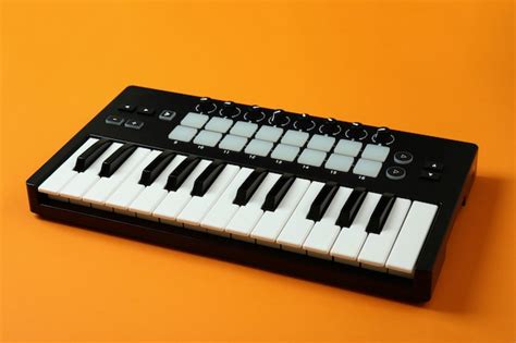 Premium Photo Midi Keyboard On Orange Background Digital Musical Instrument
