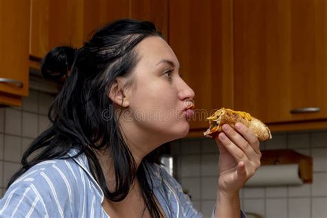 A Plump Young Woman Eats Pita Bread With Meat On The Background Of The