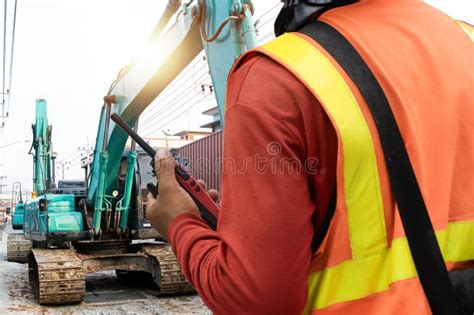 Engineers Use Radio Communication Devices To Control The Operation Of Machine Operators Stock