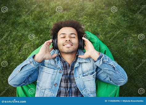 Верхний портрет взгляда довольного расслабленного Афро американского человека при щетинка лежа