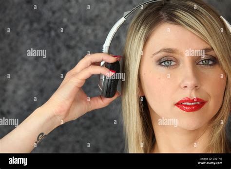 Woman Putting On A Pair Of Headphones Stock Photo Alamy