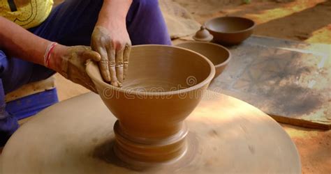 Skilled Hands Of Potter Shaping The Clay On Potter Wheel And Sculpting