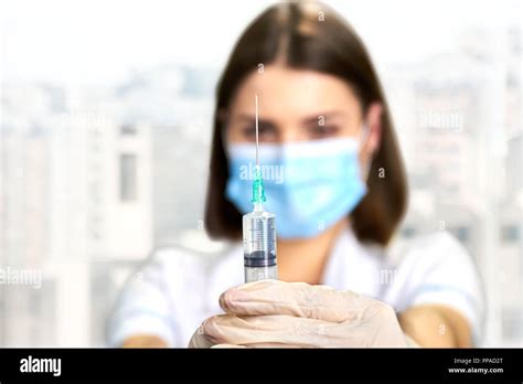 Close Up Syringe In Nurse Hands Injection In Female Doctors Hands