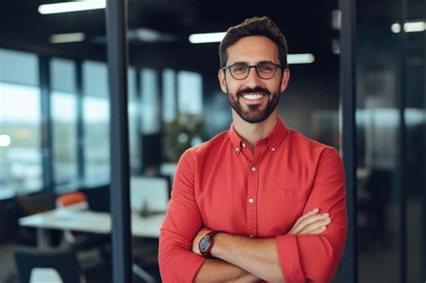 Portrait Of A Happy And Smiling Programmer In The Middle Of A Modern Office A Man In Glasses