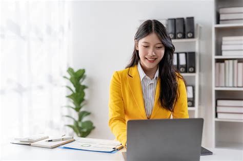 사무실에서 노트북 컴퓨터를 사용하는 미소 짓는 Sian 사업가 사무실에 행복하게 앉아 있는 자신감 넘치는 아시아 여성 사업가 20 24세에 대한 스톡 사진 및 기타 이미지