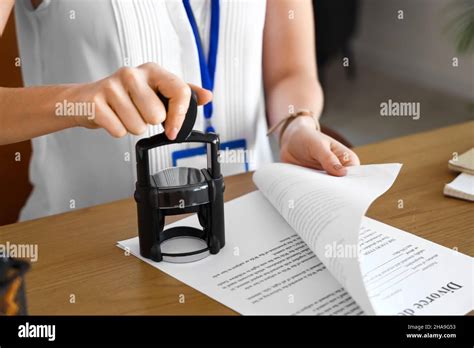 Female Notary Public Attaching Seal To Document In Office Closeup Stock Photo Alamy