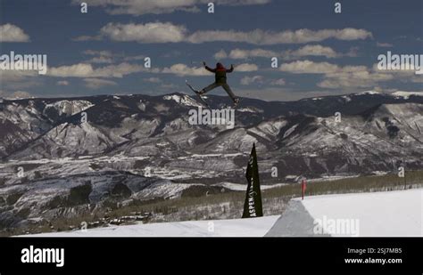 Male Skier Going Large Big Air Spread Eagle Jump Spring Time At