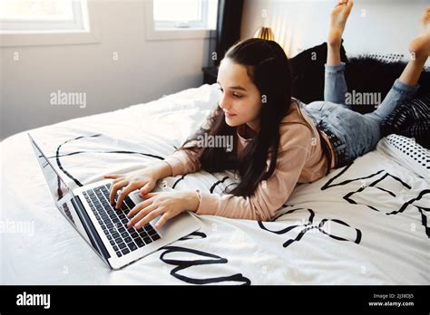 Nice Teenage Girl Using A Computer In Her Bedroom Stock Photo Alamy