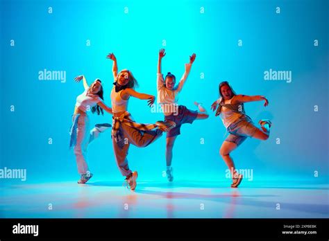 Artistic Girls Dancers In Casual Streetwear Perform Bold Poses Against