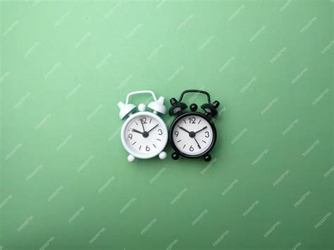 Premium Photo Black And White Alarm Clock On A Green Background
