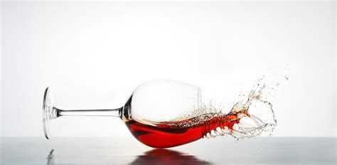 Premium Photo Close Up Of Red Wine Spilling From Glass Against White