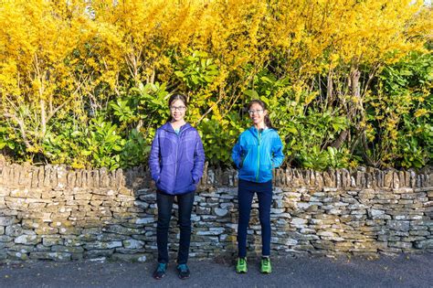 Happy Asian Girls Standing In Front Of Old Stone Wall With Majestic