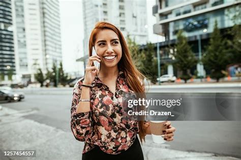Latin Women Outdoors Using Mobile Phone In Downtown High Res Stock