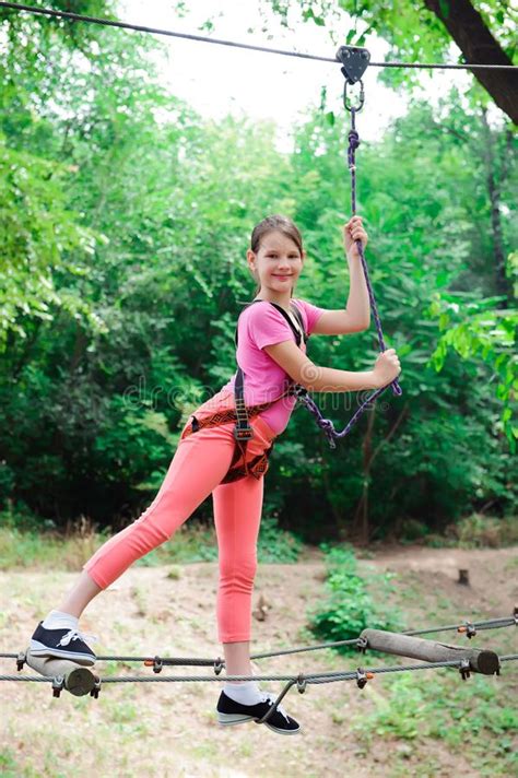 Adventure Climbing High Wire Park Hiking In The Rope Park Girl In Safety Equipment Stock Image