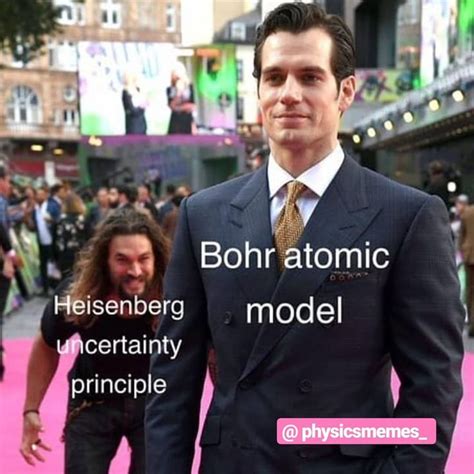 A Man In A Suit And Tie Walking Down A Pink Carpeted Area With Other People