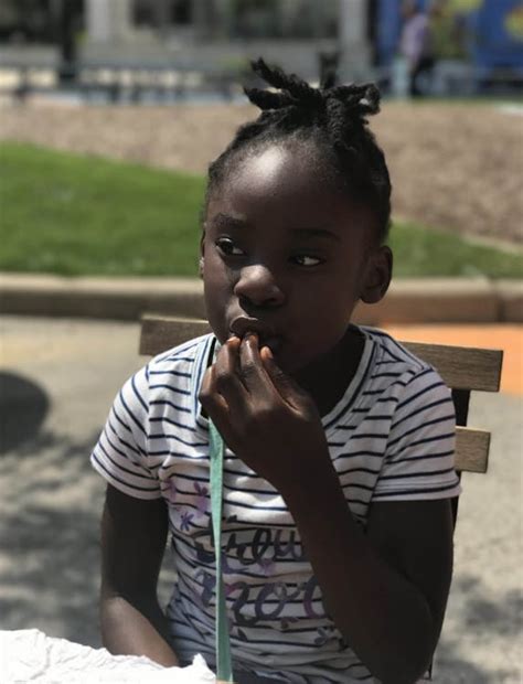 Girl With Her Fingers In Mouth While Sitting On A Wooden Chair · Free