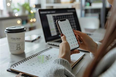 Person Multitasking With Phone And Laptop On Desk Premium Ai Generated Image